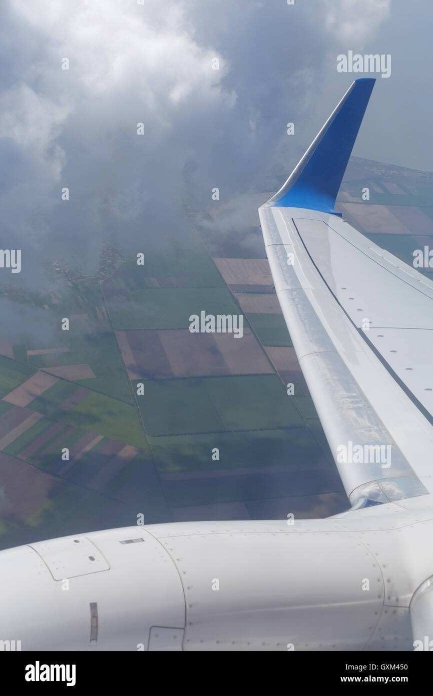 wing of aircraft flying above fields Stock Photo - Alamy