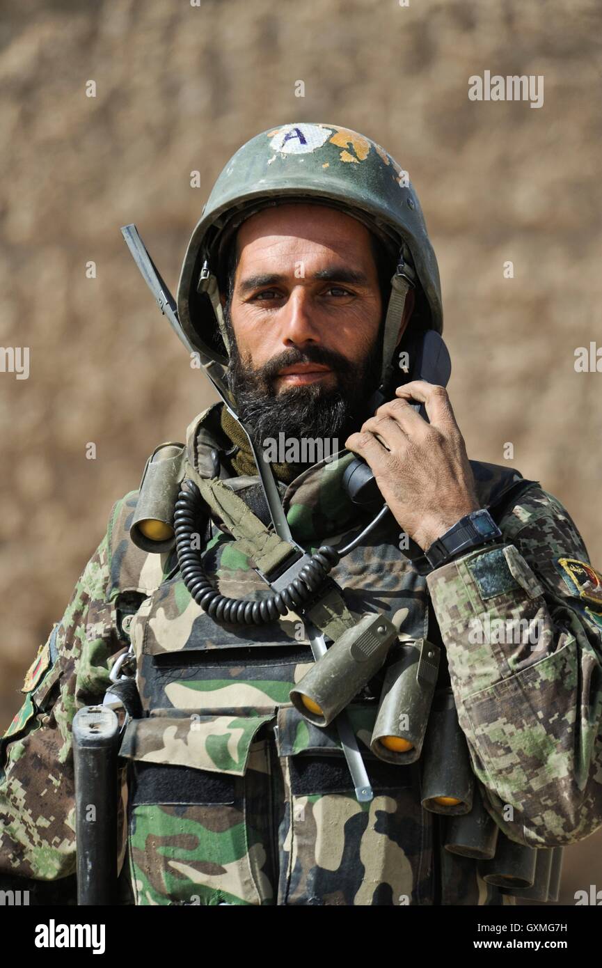 An Afghan National Army soldier uses a phone during a security patrol ...
