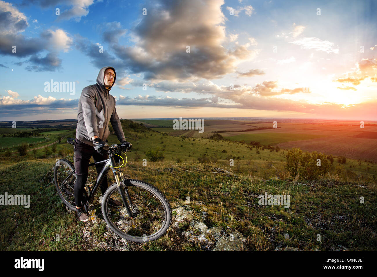 Woman cycling through grass field hi-res stock photography and images ...