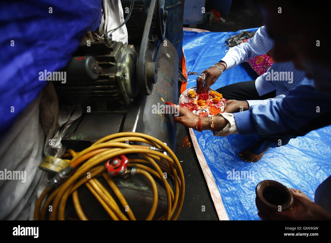 Kathmandu, Nepal. 17th Sep, 2016. A mechanic offering prayers to ...