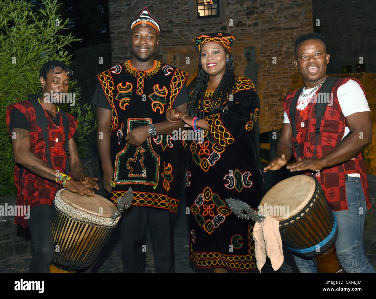 Framed by musicians, Samuel Awasum and his wife Jacinta Awusa Awasum (C ...