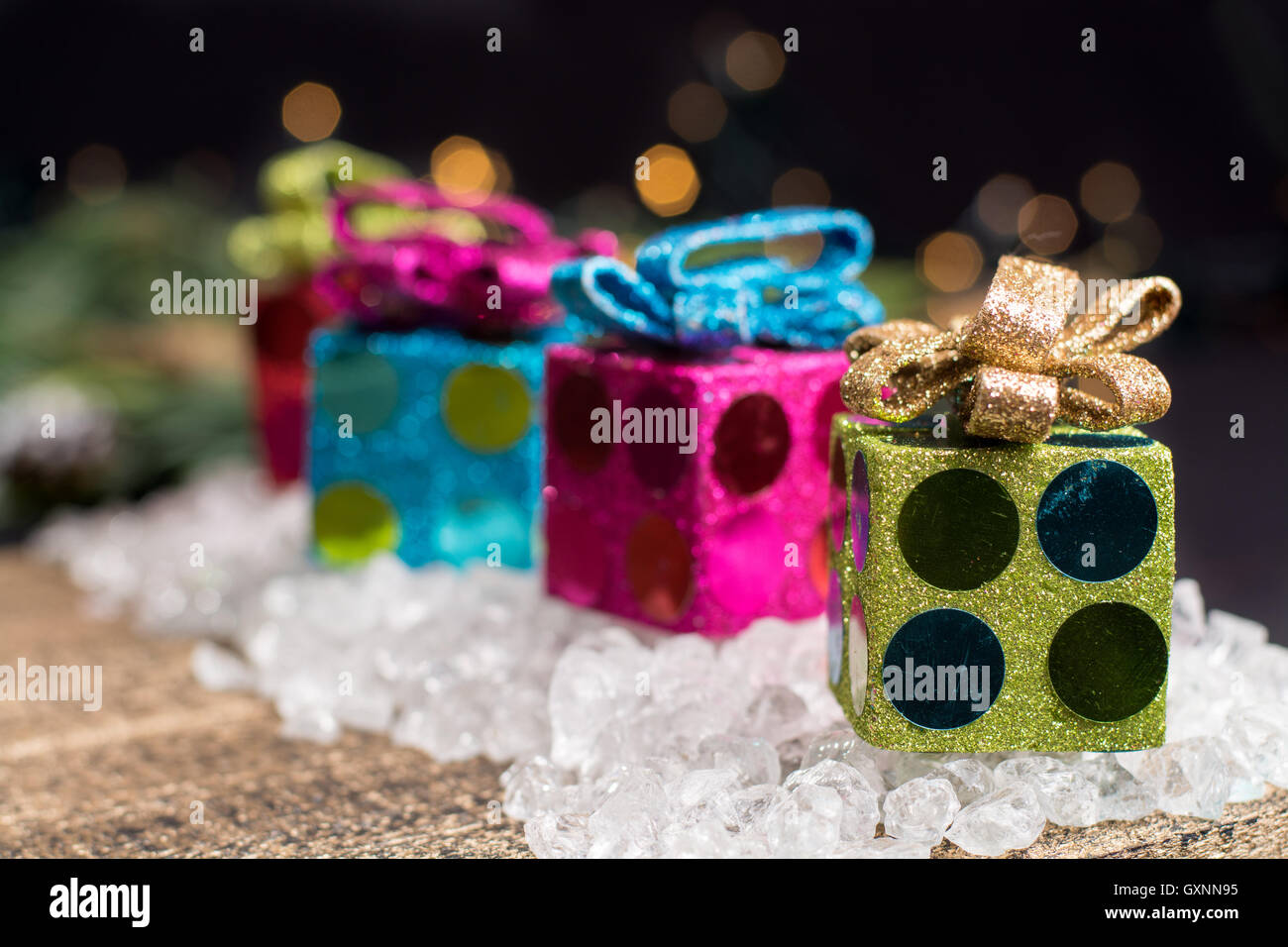 Christmas decoration, colorful gift boxes on crystal ice and golden ...