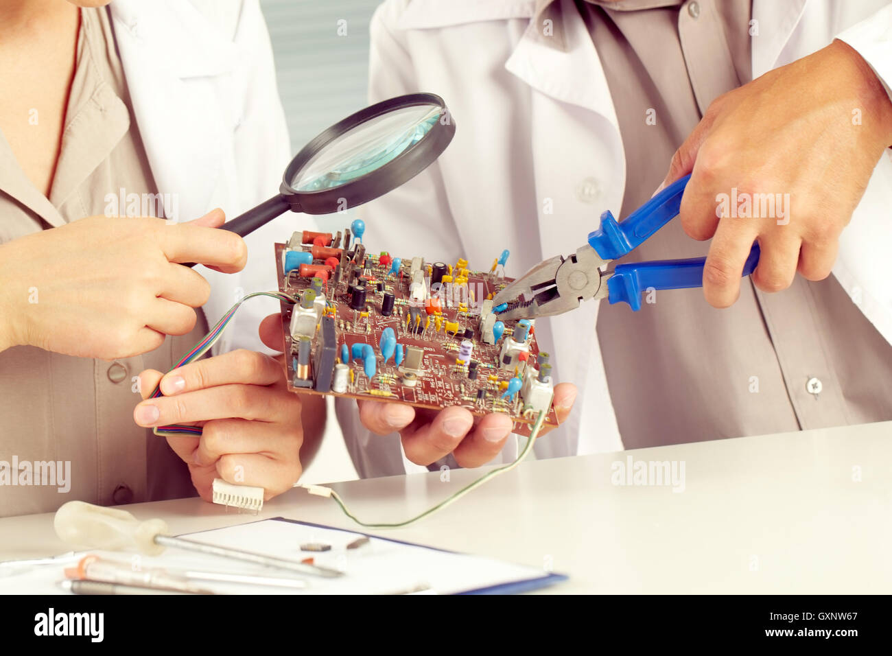 Working with circuit board Stock Photo - Alamy