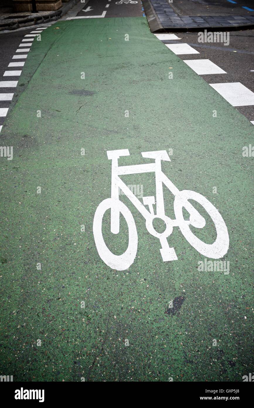 Bike lane sign painted on a street Stock Photo - Alamy