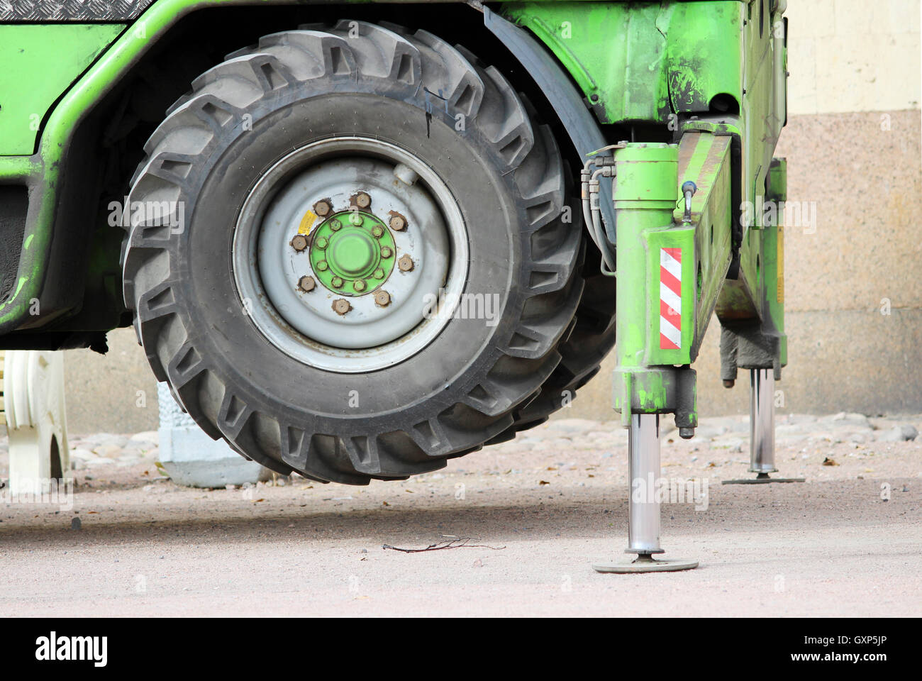 Truck strong outrigger stabilizing legs extended. Boom lifts building ...