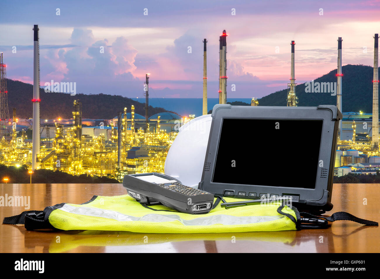 Smart factory - Rugged computers tablet in front of oil refinery ...