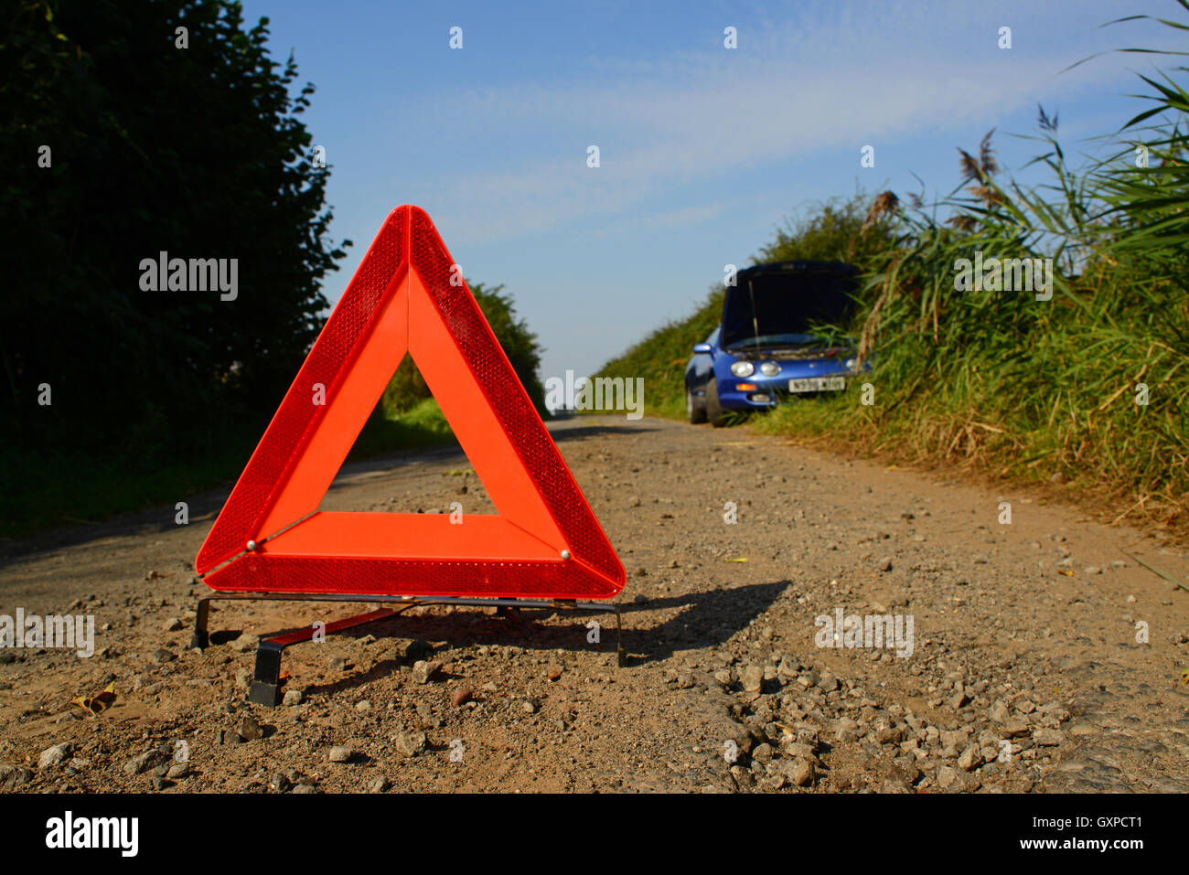 hazard warning triangle by broken down car on country road near york ...