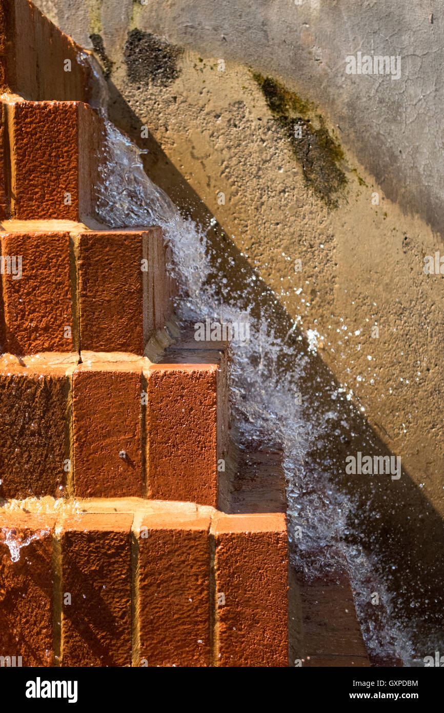 Concrete and brick water fountain in a city Stock Photo - Alamy