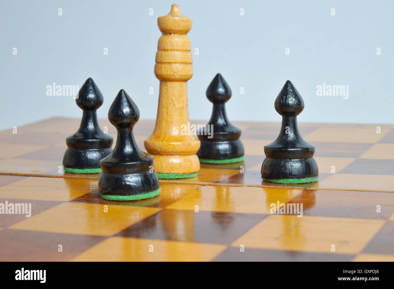 King surrounded by pawns on a white background. games and themes Stock ...