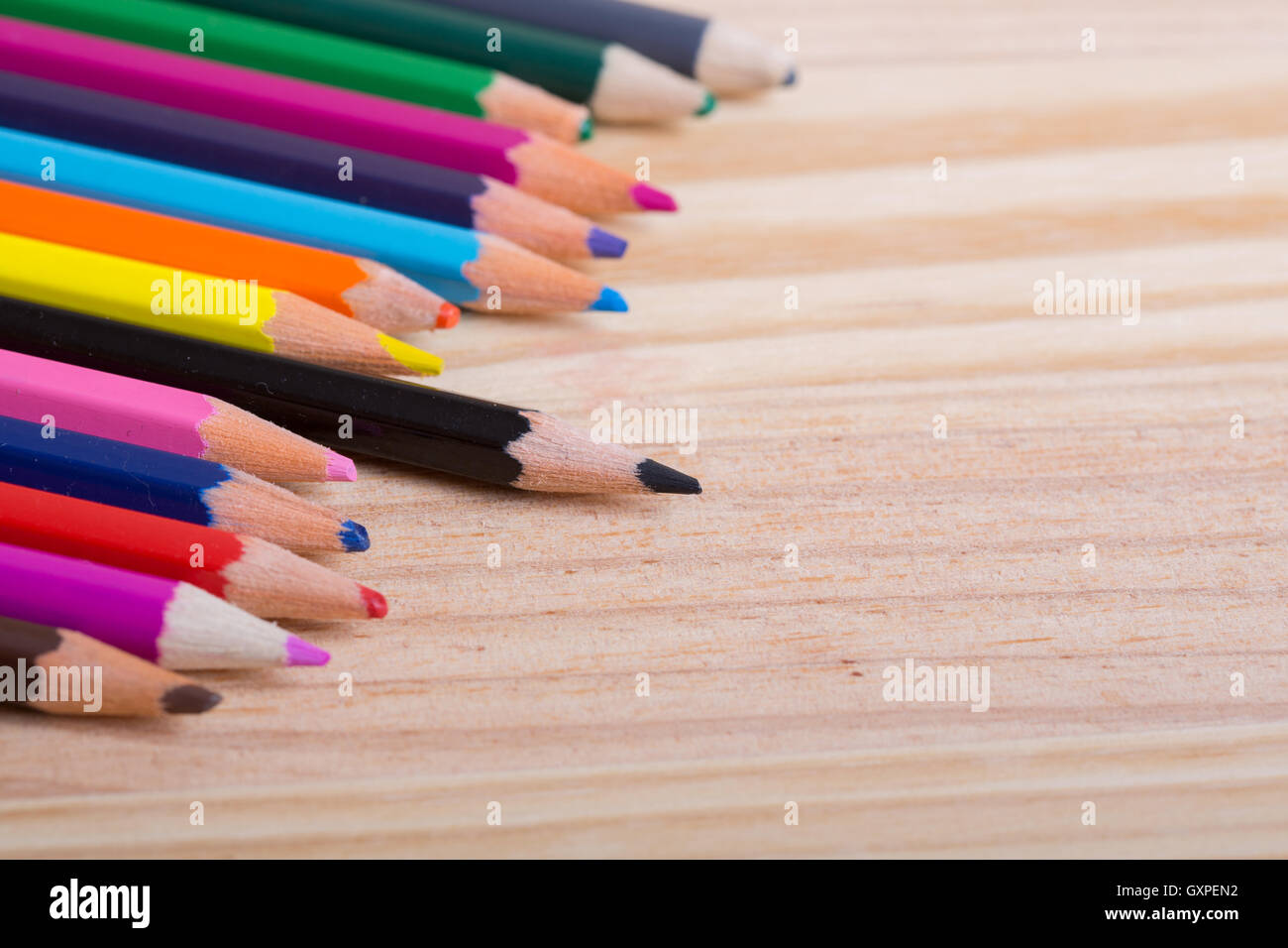 colored pencils on the wooden background Stock Photo - Alamy