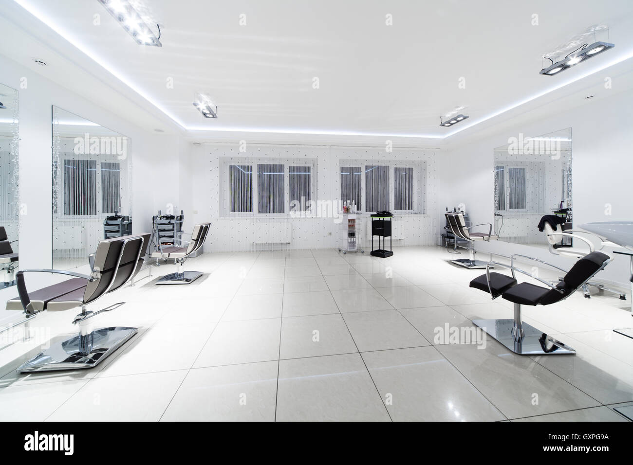 chairs and mirrors in modern hairdressing Stock Photo - Alamy