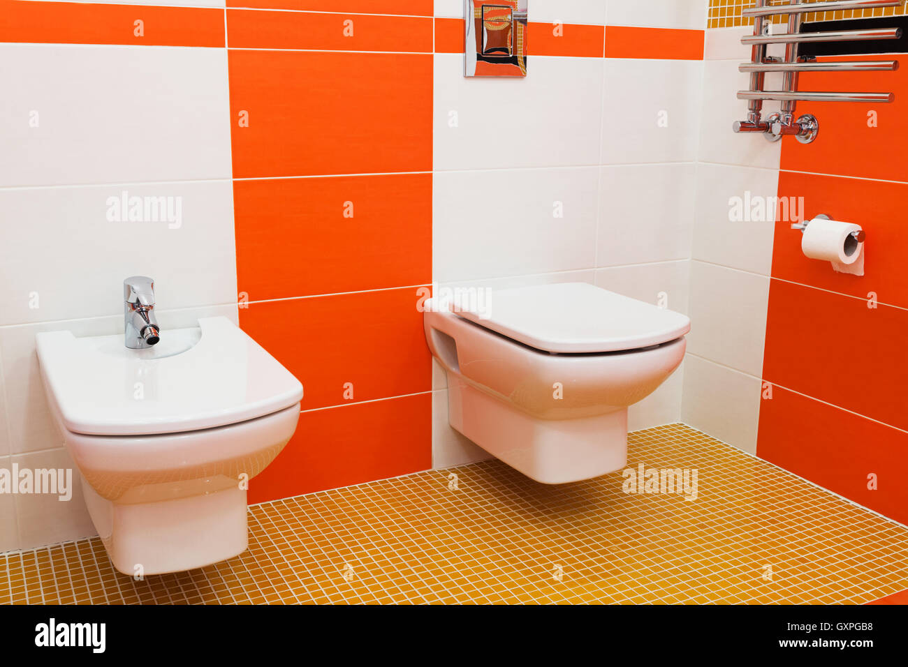 WC and bidet in a beautiful orange bathroom Stock Photo - Alamy