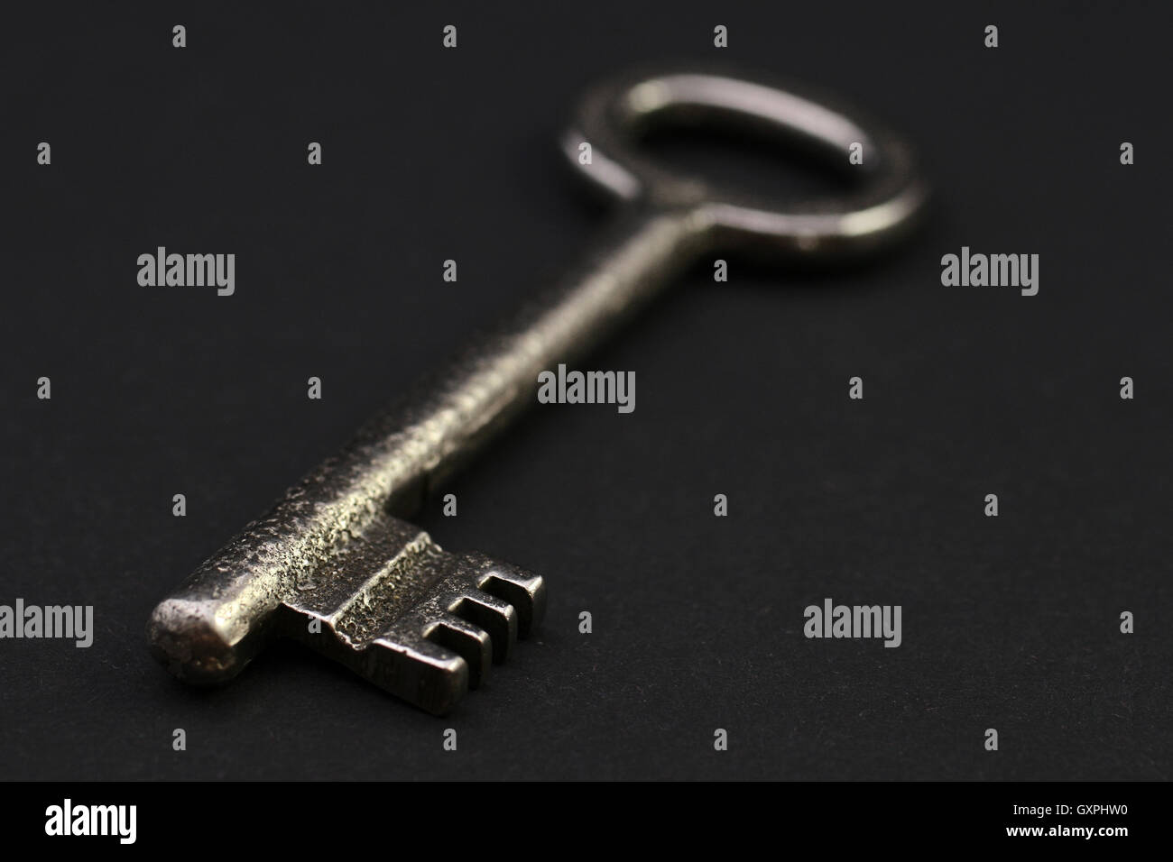 Old key on black background Stock Photo - Alamy