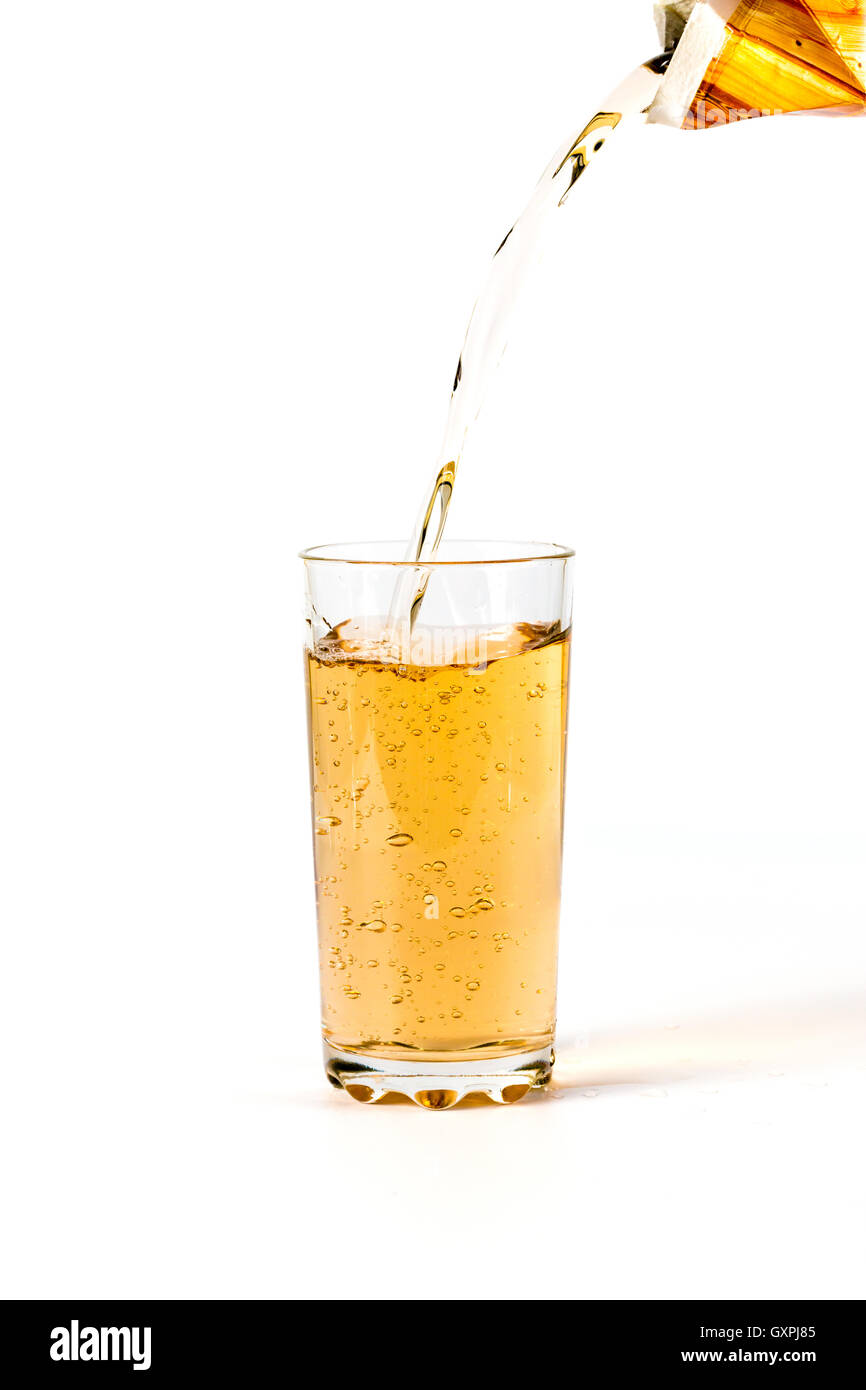 Fruit juice is poured into a beaker on a white background Stock Photo ...