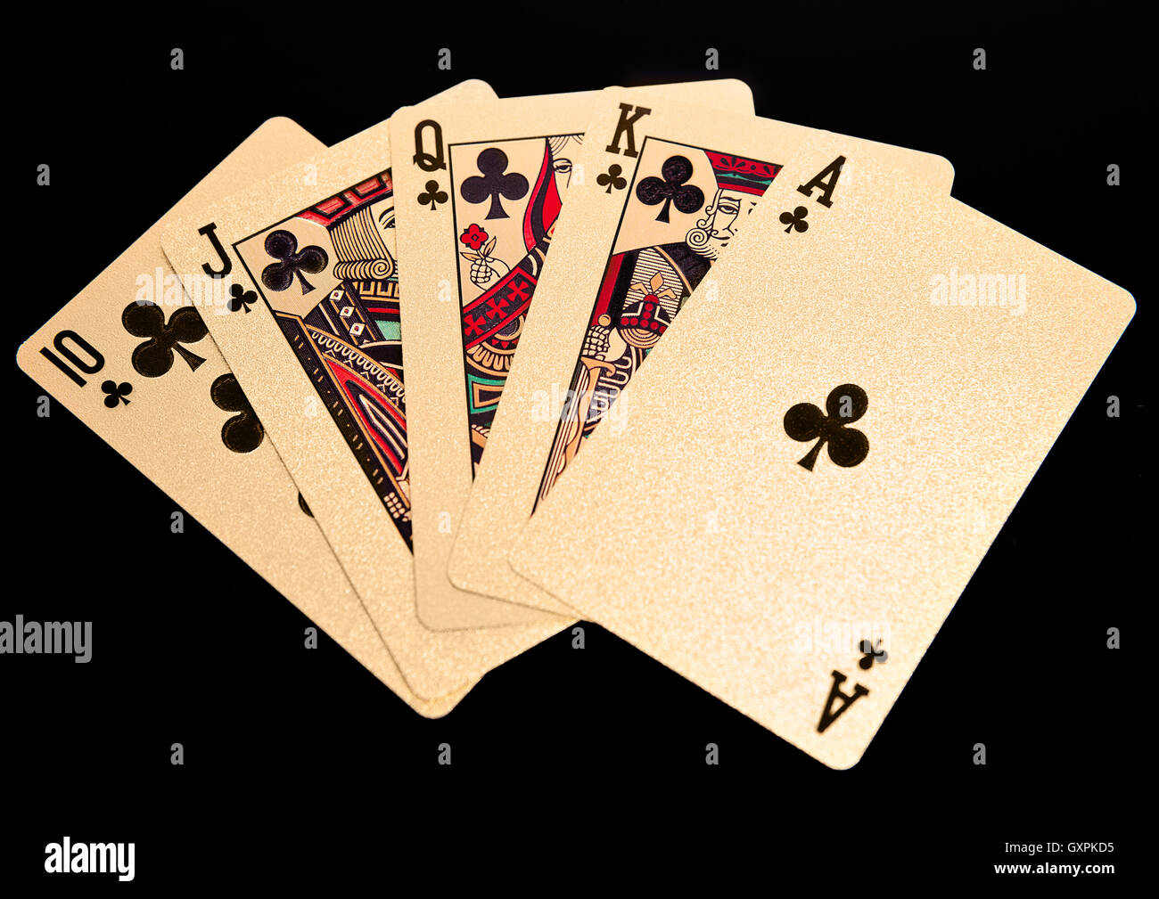Royal straight flush golden playing cards poker hand. On black ...