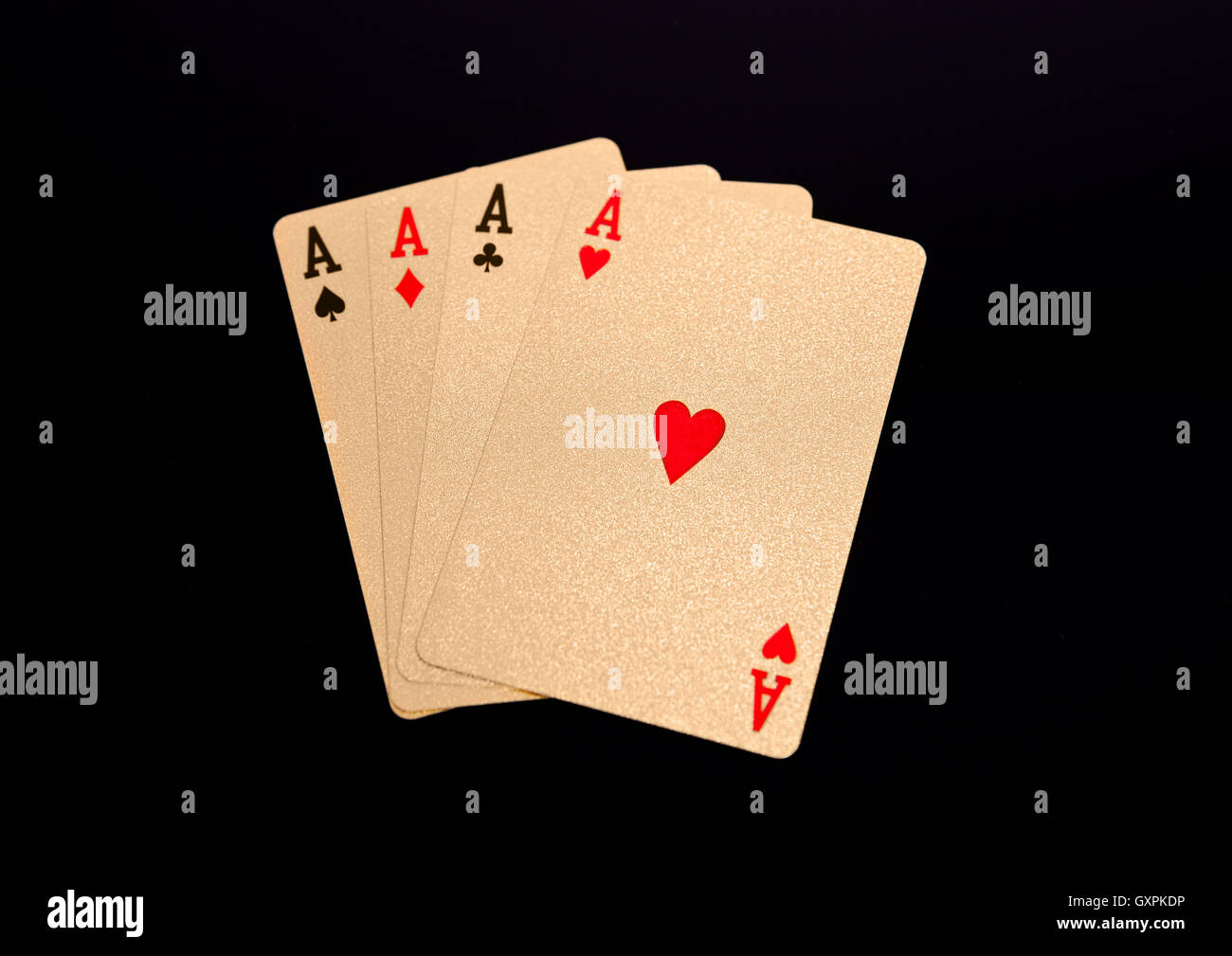 Golden playing cards four aces on black background Stock Photo - Alamy
