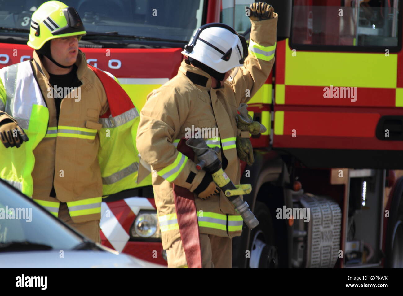 Firefighters signals water on command as he prepares to tackle a ...