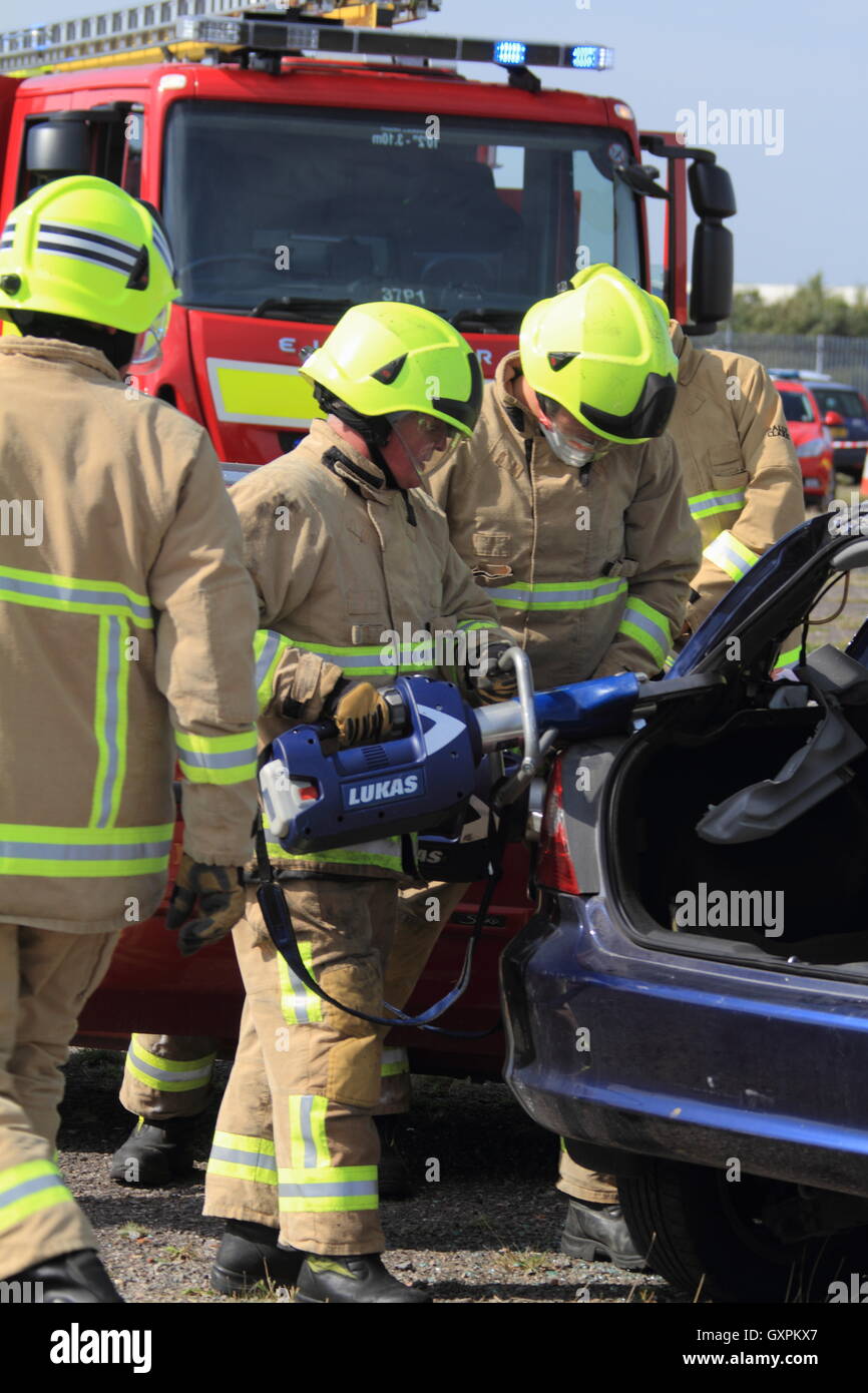 Firefighters using Lukas cutting equipment to rescue a simulated ...
