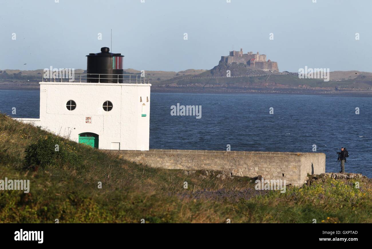 A view of Bamburgh lighthouse in Northumberland with Lindesfarne Castle ...