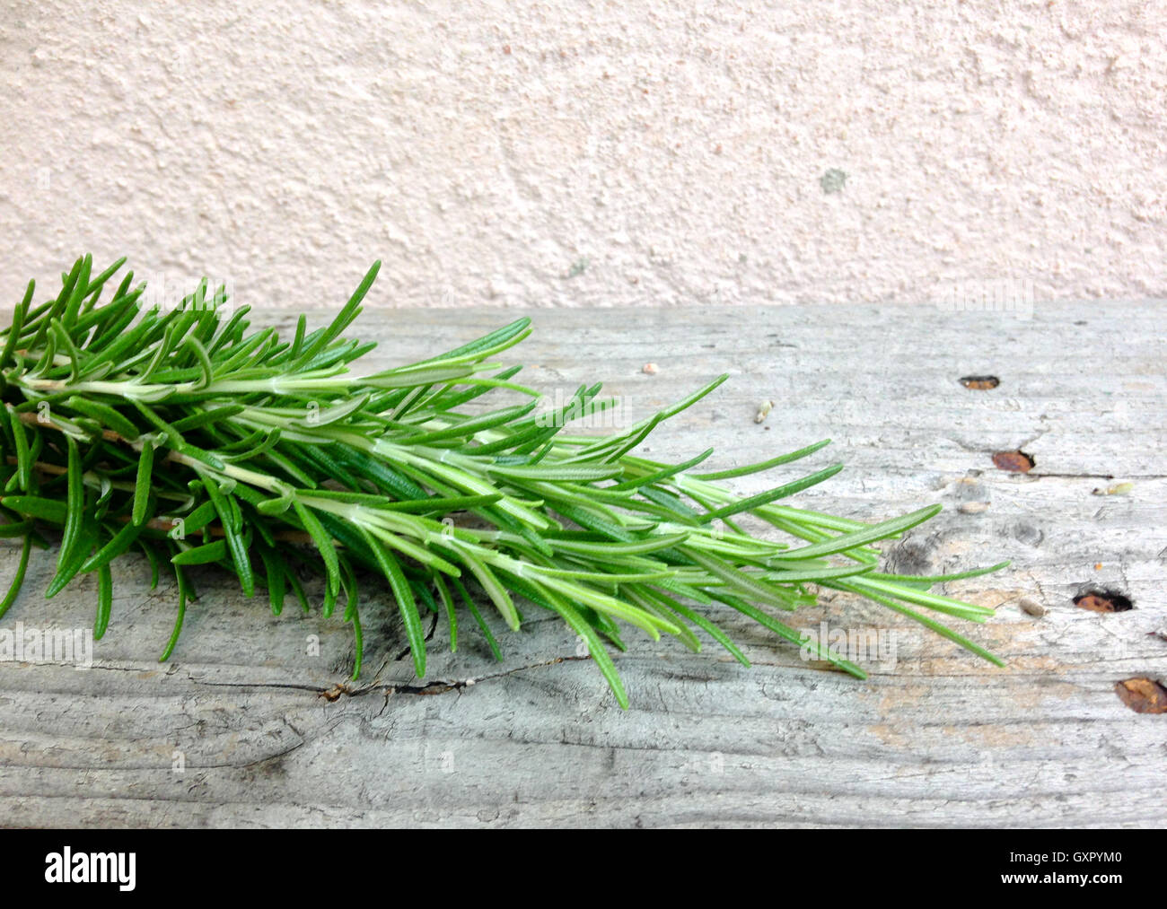 Rosemary on rustic wood background Stock Photo - Alamy