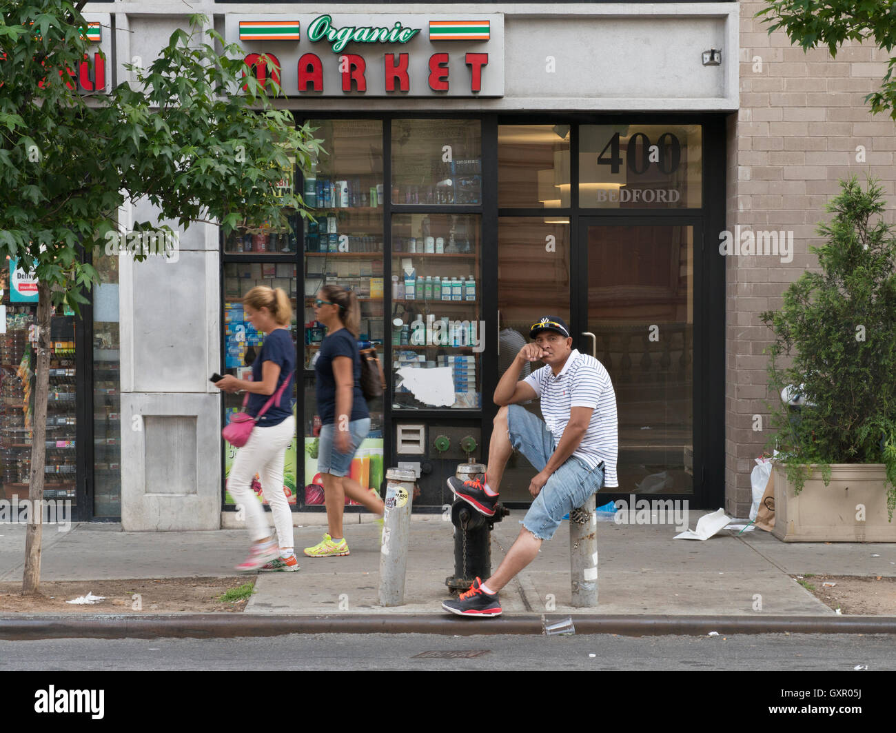 Brooklyn streetscene with walking women and thinking man Stock Photo ...