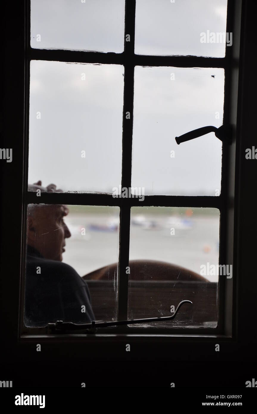Man through window thinking Stock Photo - Alamy
