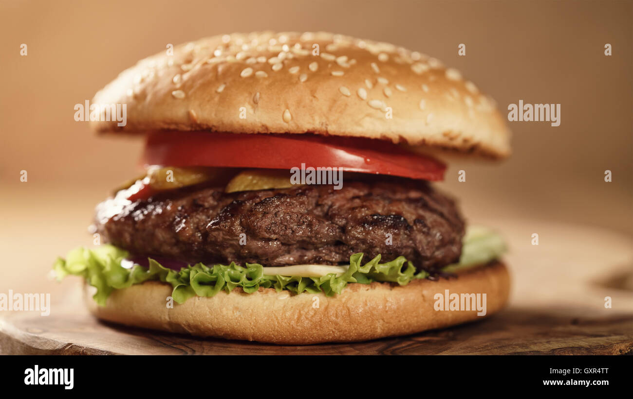 fresh homemade burger with marble beef, cheese and vegetables on olive ...