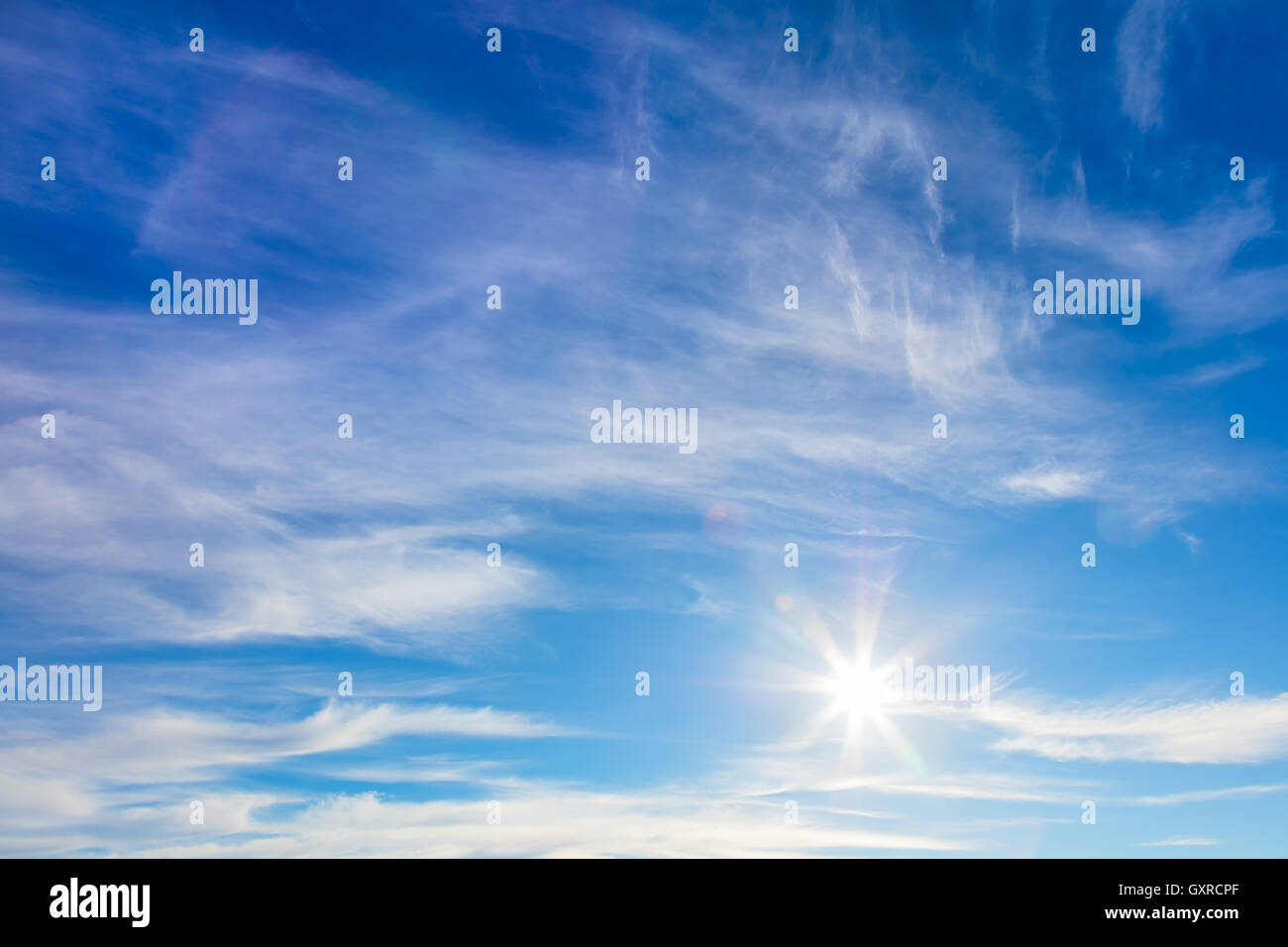 Sunny background of blue sky with real sun and light clouds, good day ...