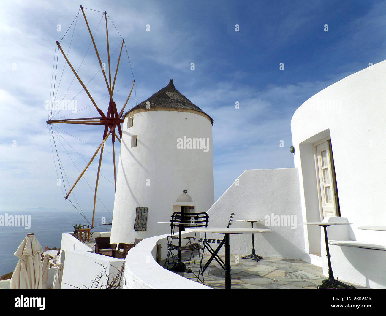 Greek Style White Windmill and Architectures in the afternoon Sunlight ...