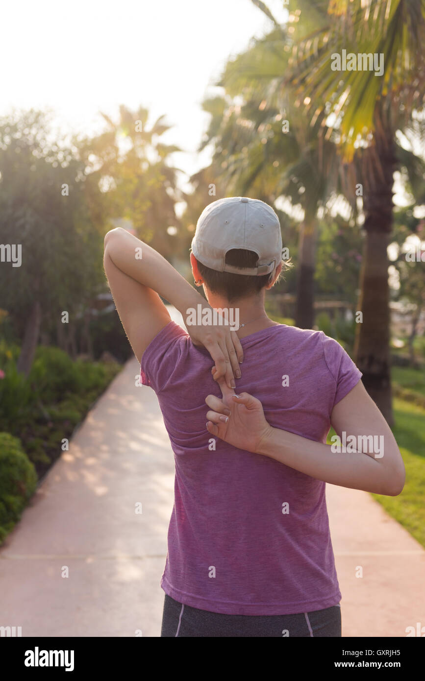 runner woman warming up and stretching before morning jogging Stock ...
