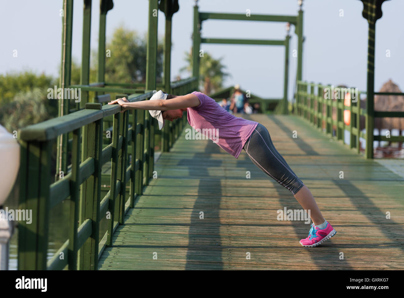 runner woman warming up and stretching before morning jogging Stock ...