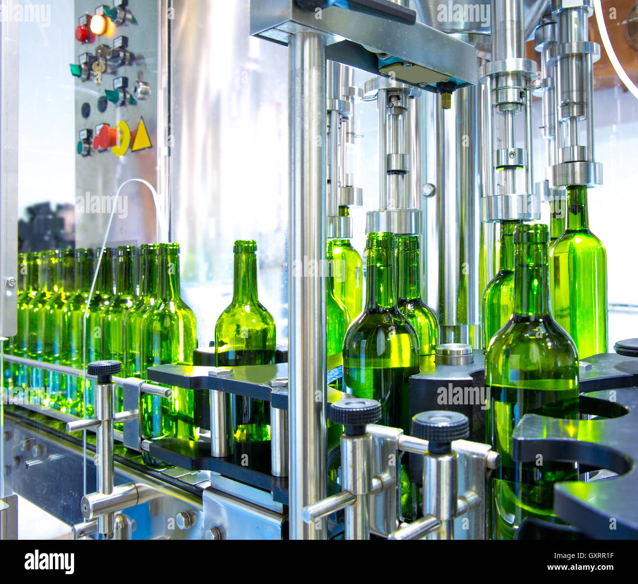 white wine in bottling machine at winery Stock Photo - Alamy