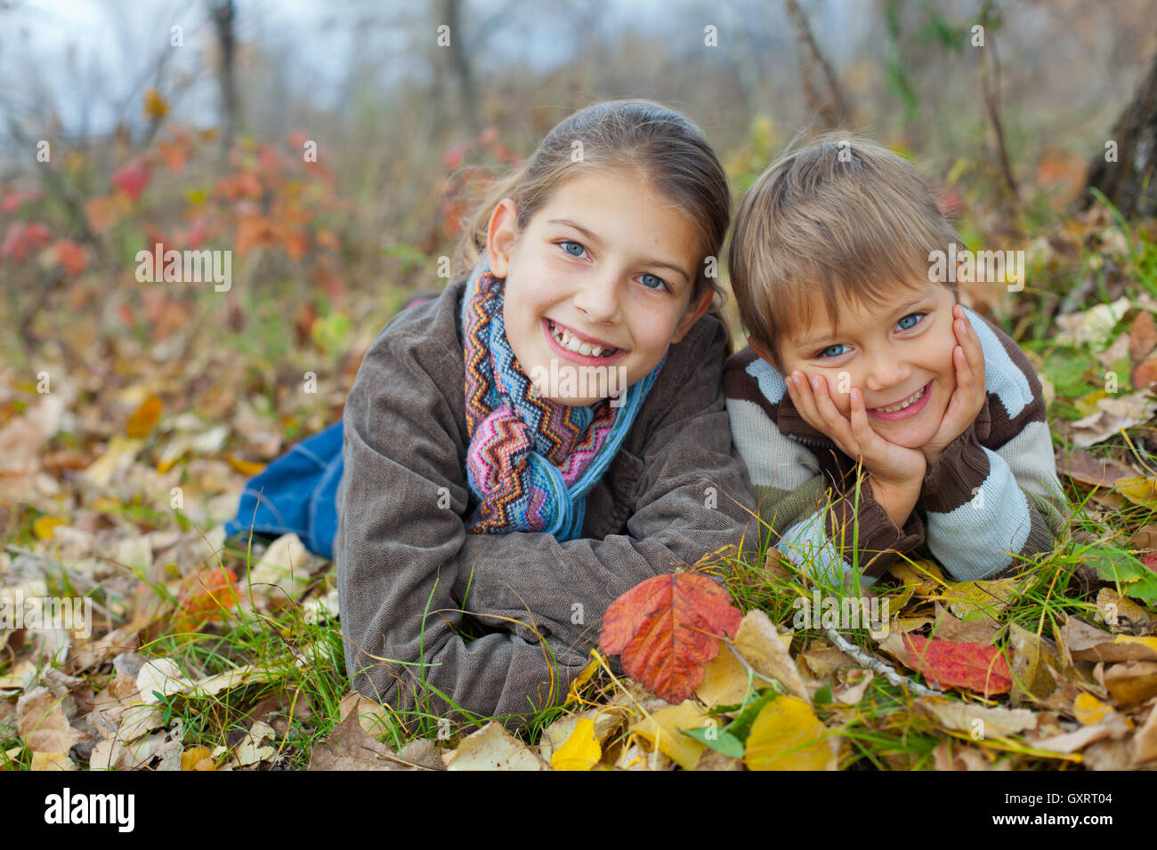 Kids in autumn park Stock Photo - Alamy
