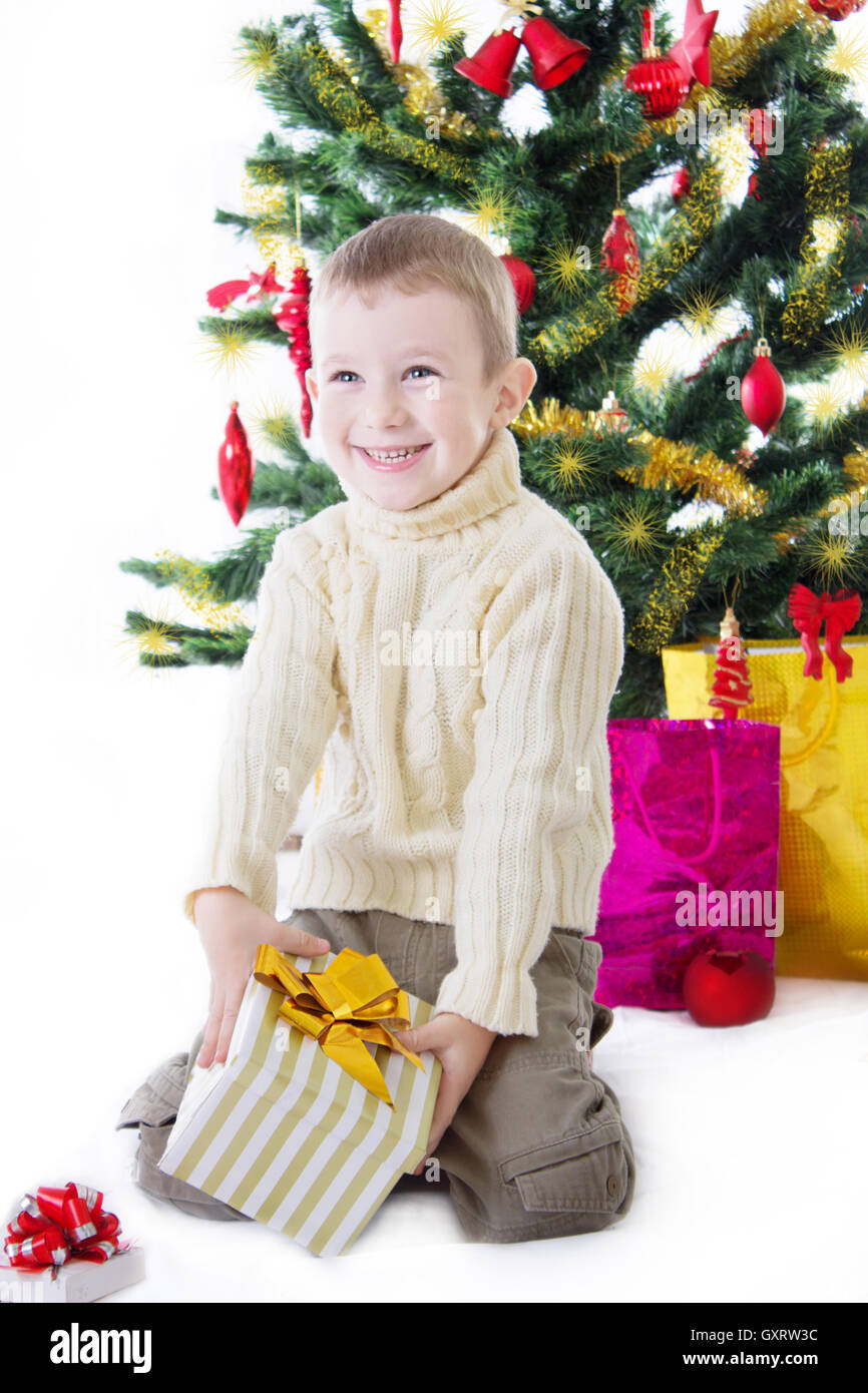 Boy with present box under Christmas tree Stock Photo - Alamy