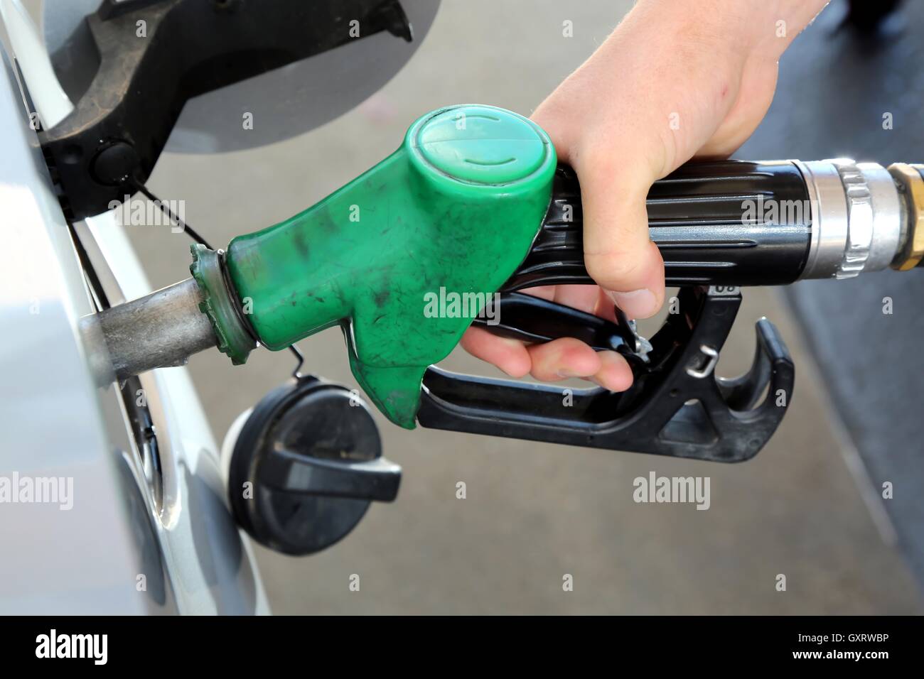 Gas Station Refill Hand and Nozzle Stock Photo - Alamy