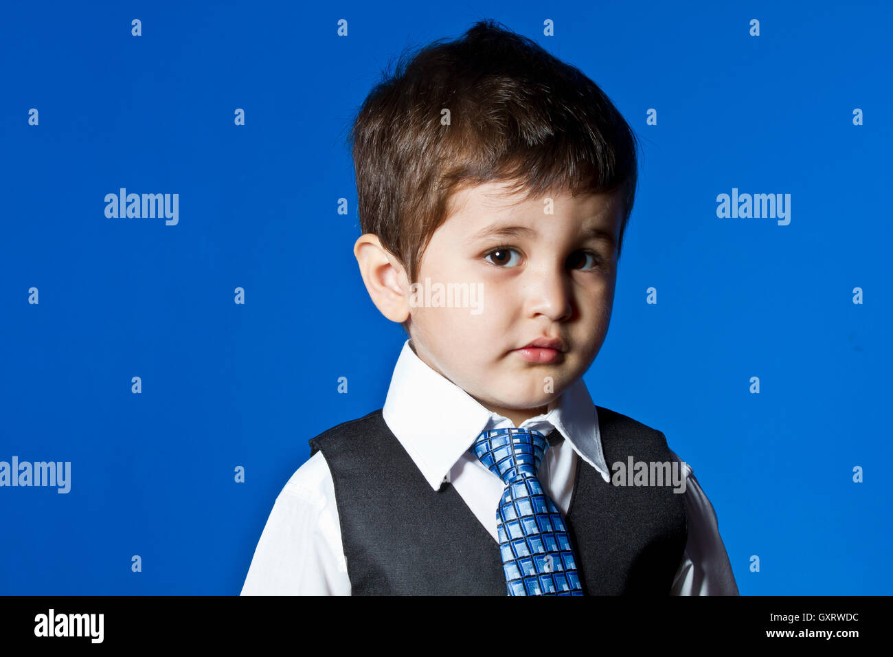 Leader, cute little boy portrait over blue chroma background Stock ...