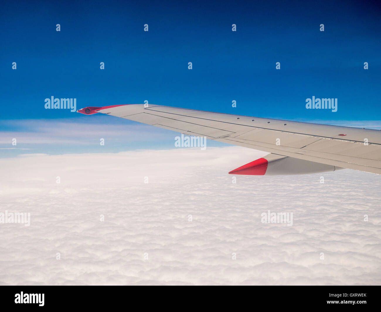 View through plane window with wing and clouds Stock Photo - Alamy