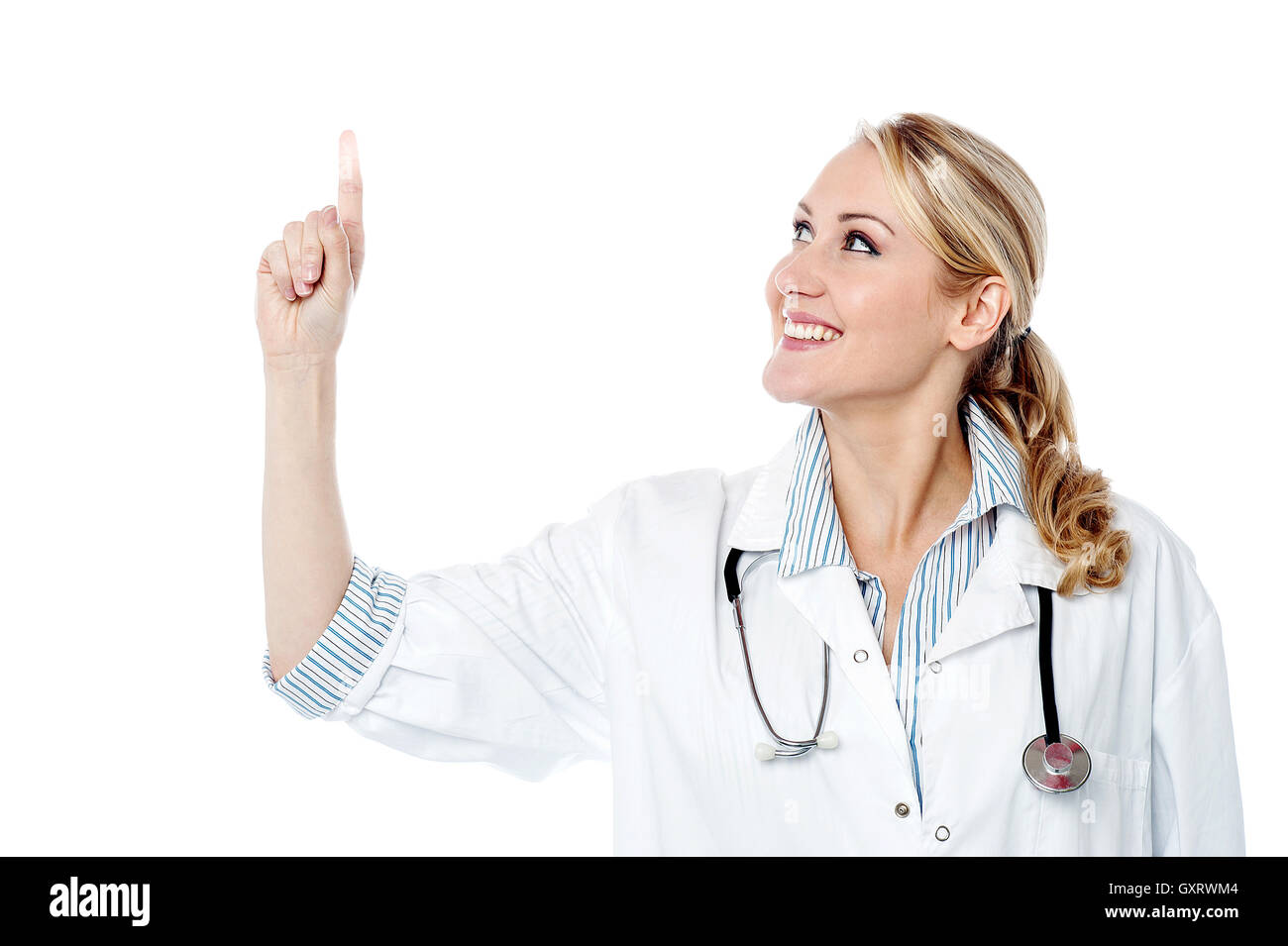 Smiling female doctor pointing upwards Stock Photo - Alamy
