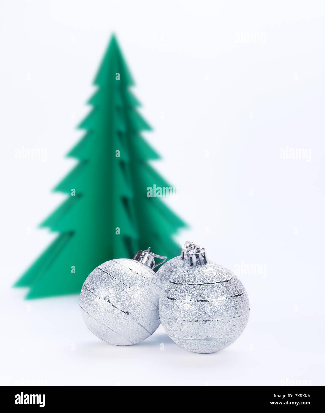 Christmas decorations and green paper tree on a white background Stock ...
