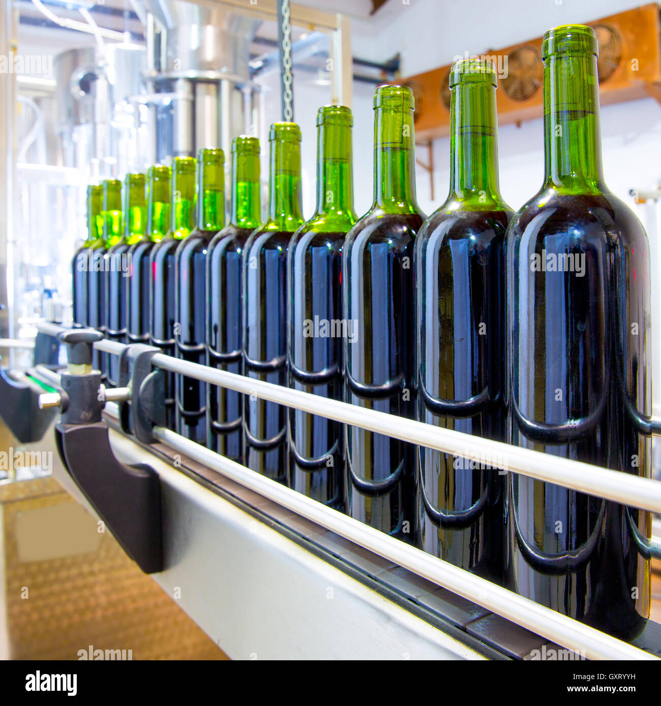 red wine in bottling machine at winery Stock Photo - Alamy