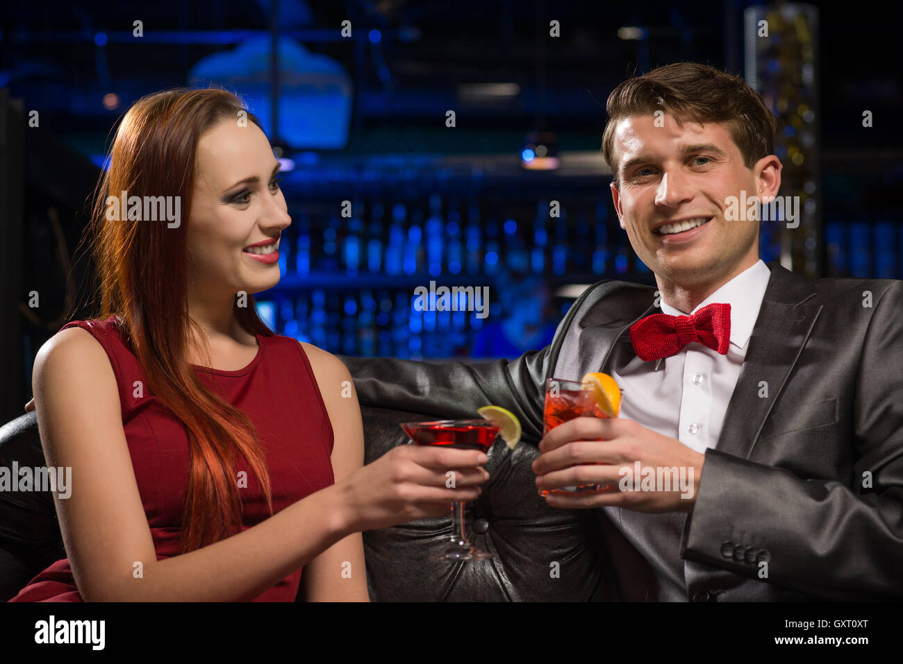Young couple talking in a nightclub Stock Photo - Alamy