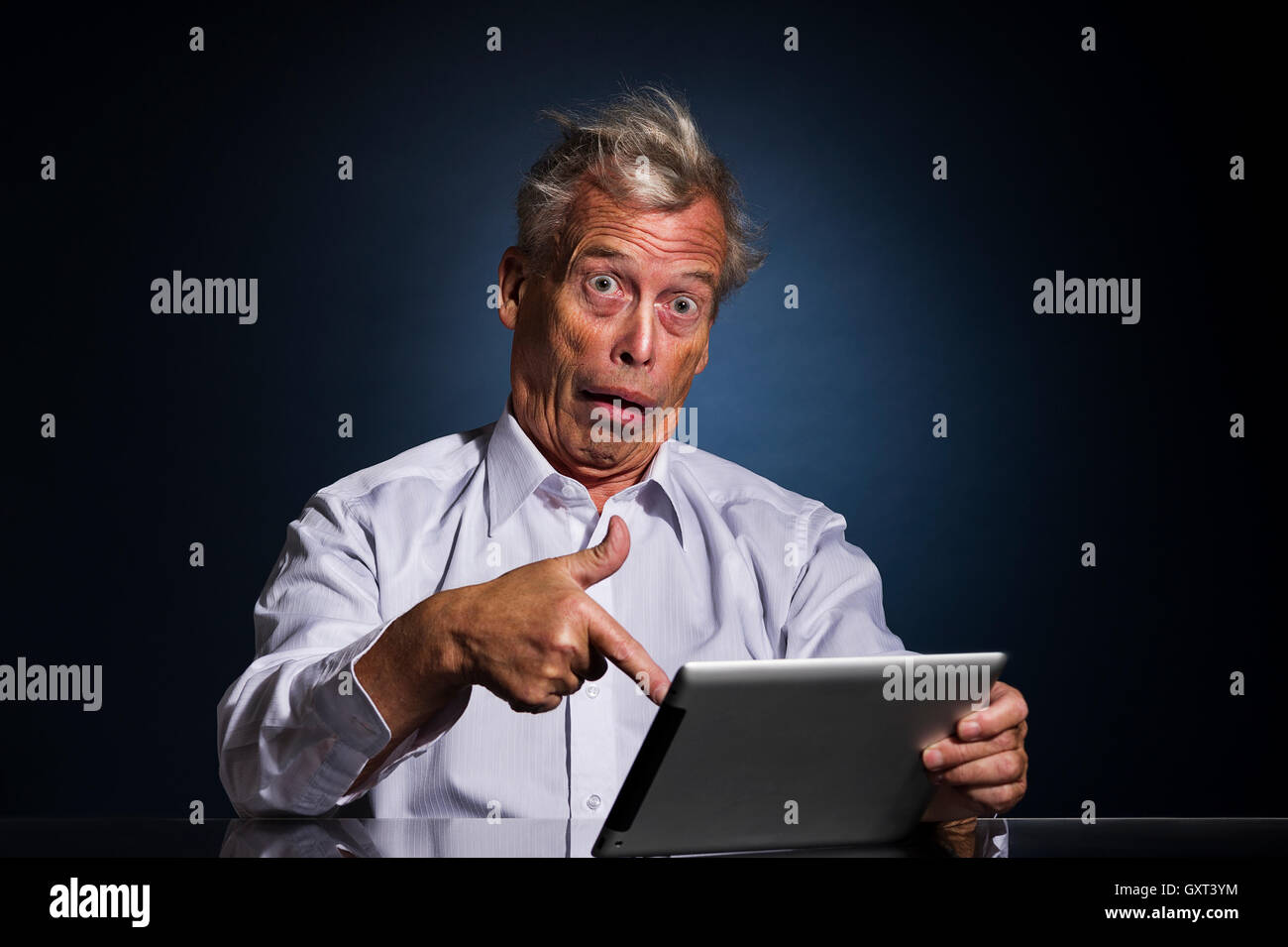 Senior man presenting tablet hi-res stock photography and images - Alamy