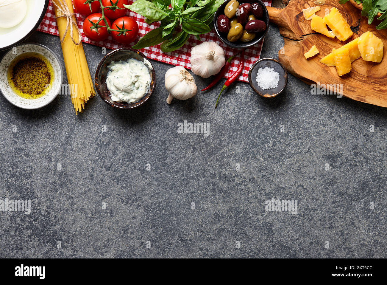 Italian food ingredients background with raw spaghetti, olives, basil ...