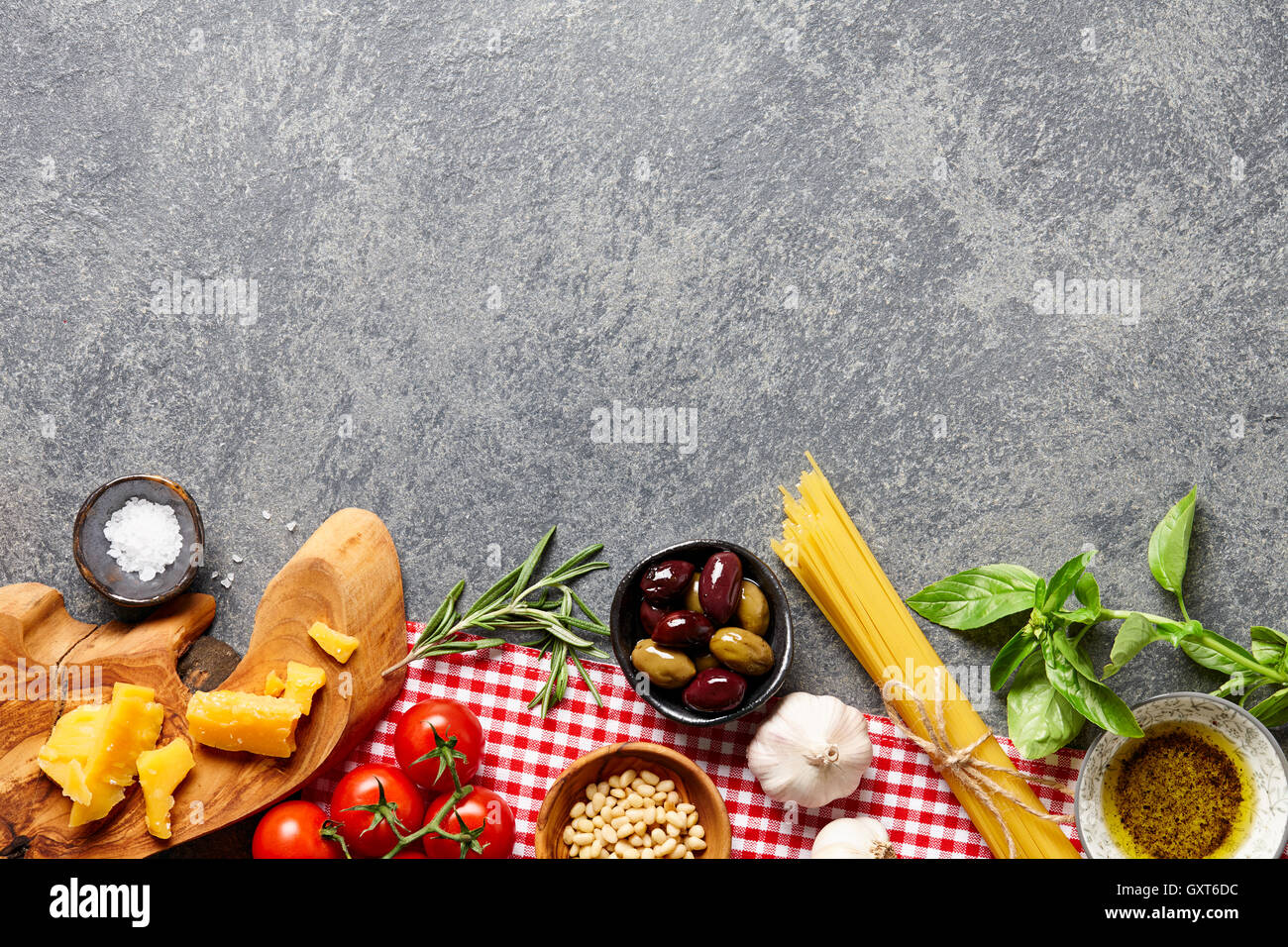Italian food ingredients background with raw spaghetti, olives, basil ...