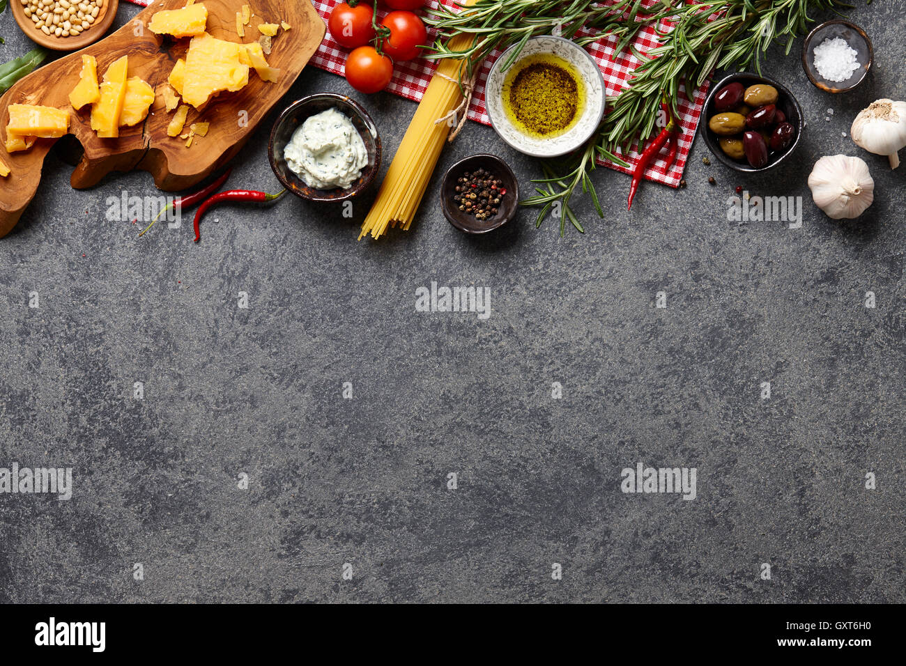 Italian food ingredients background with raw spaghetti, olives, basil ...