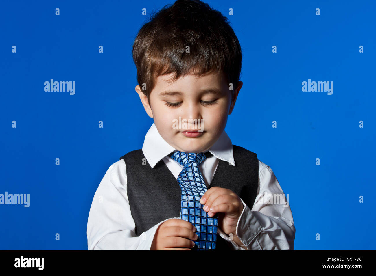 Positivity, cute little boy portrait over blue chroma background Stock ...