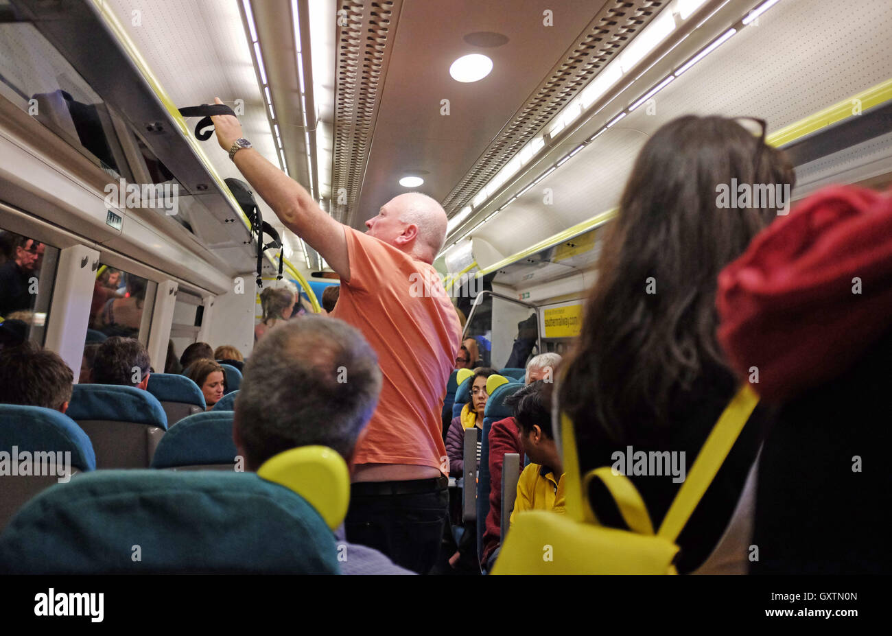 Crowded packed Southern Rail train carriage with passengers having to ...