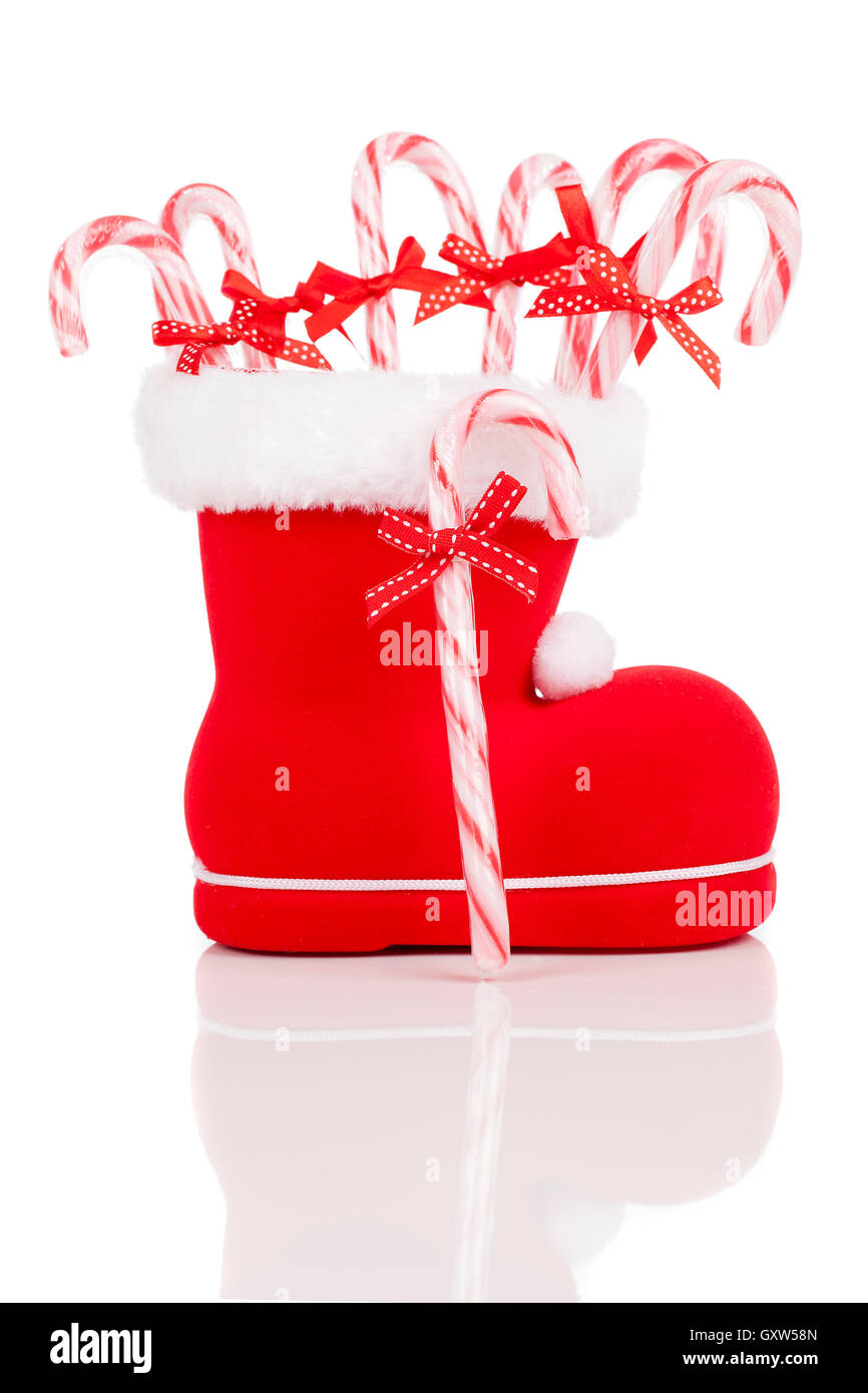 Santa's boot with candy canes on white background Stock Photo - Alamy