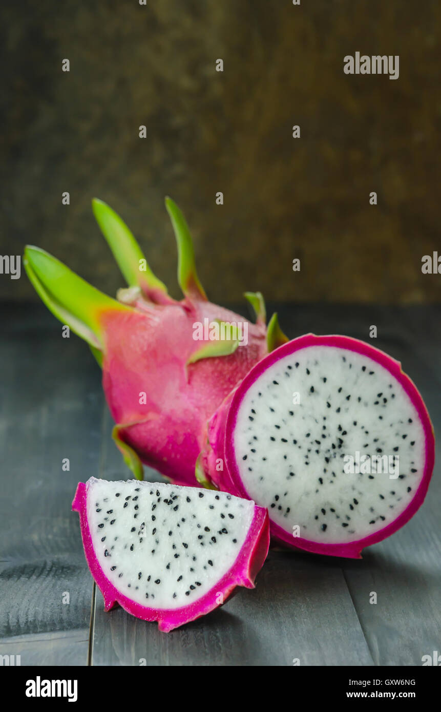Ripe Dragon fruit or Pitaya with slice on wooden background , still ...
