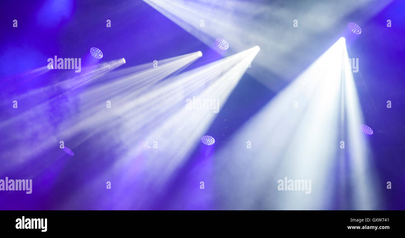 Stage lights on electric concert on blue background Stock Photo - Alamy